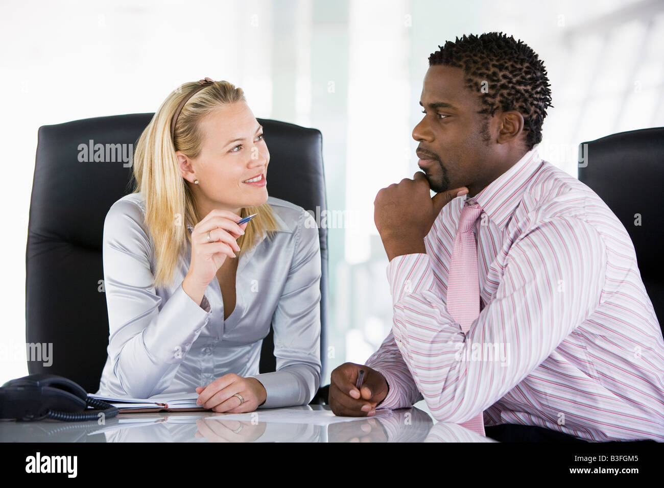 Two businesspeople in office talking Stock Photo - Alamy