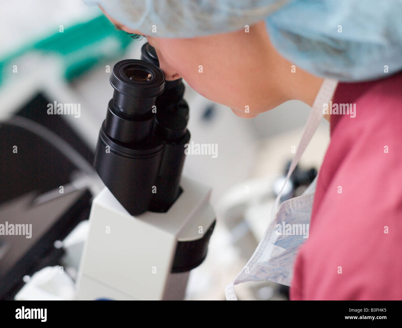Embryologist with microscope performing an intra cytoplasmic sperm ...