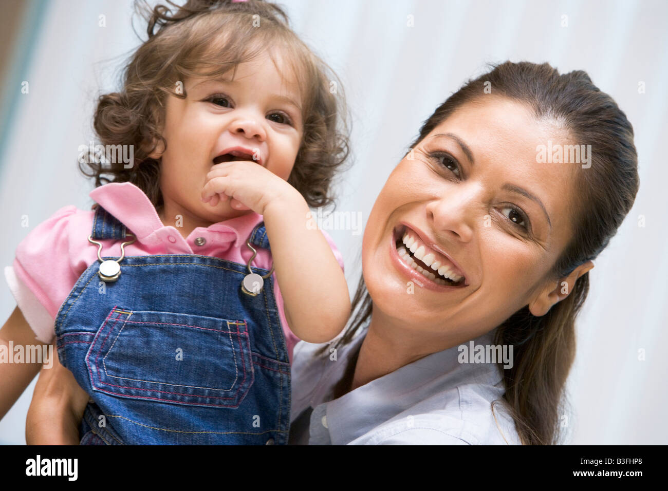 Mother holding IVF child smiling Stock Photo - Alamy