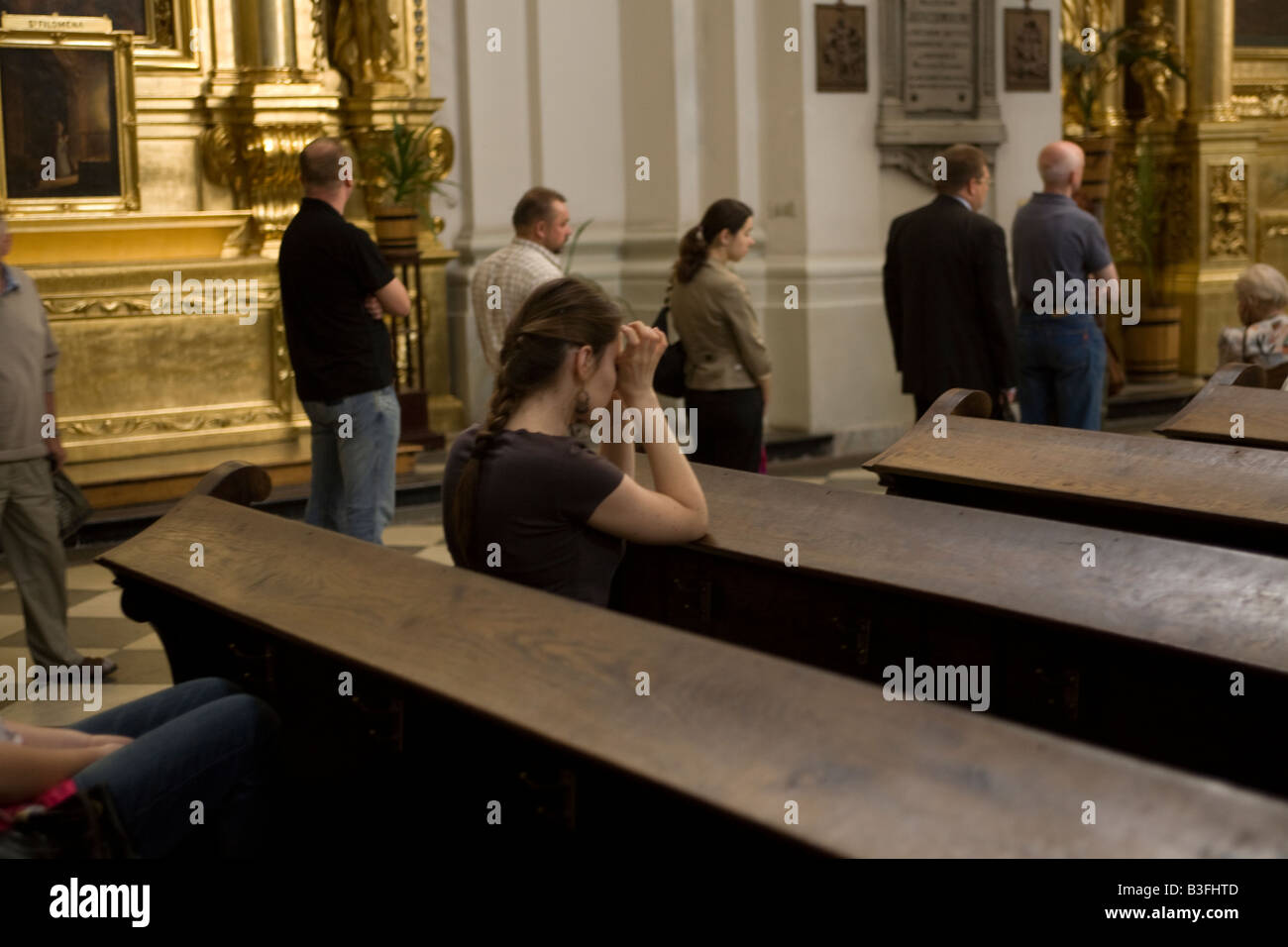 Young woman praying in a church in Krakow Poland Stock Photo - Alamy