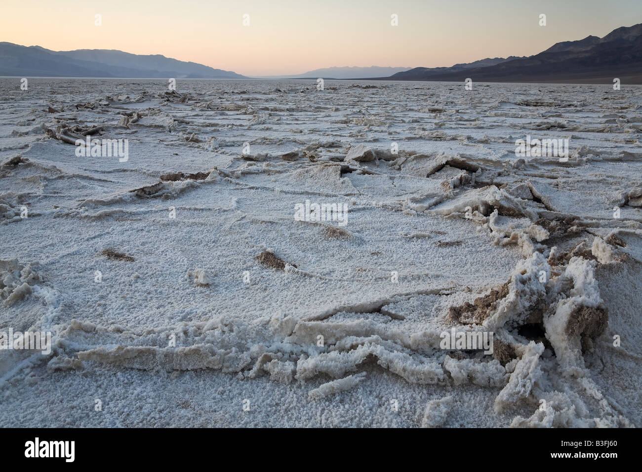 Cracked salt form a rift into the sunset, Death Valley Stock Photo - Alamy