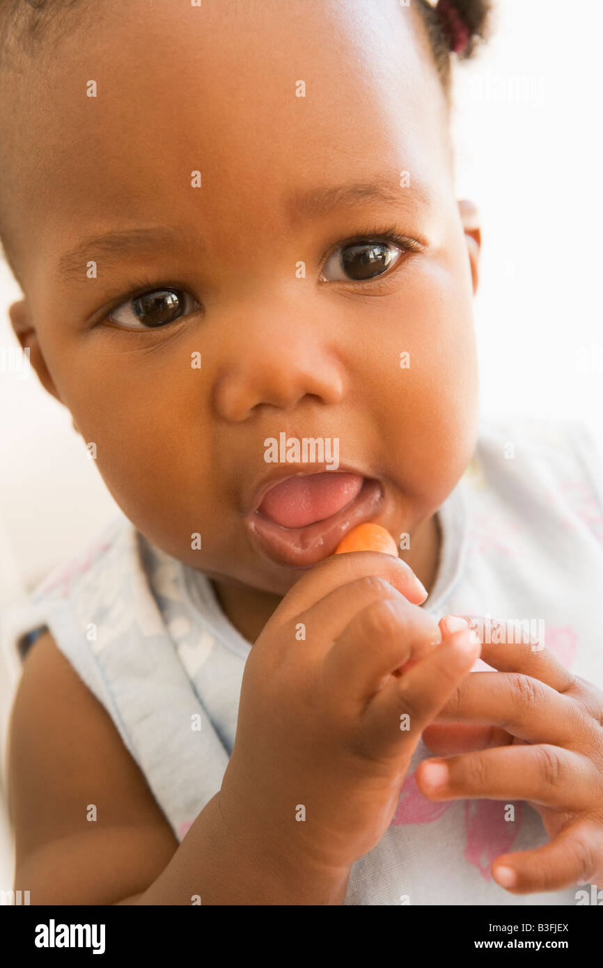 Baby eating carrot Stock Photo - Alamy