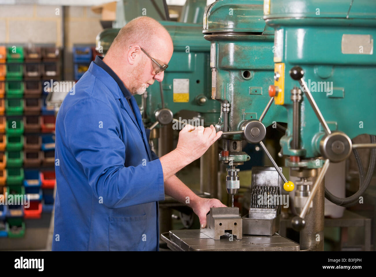 Machinist working on machine Stock Photo - Alamy
