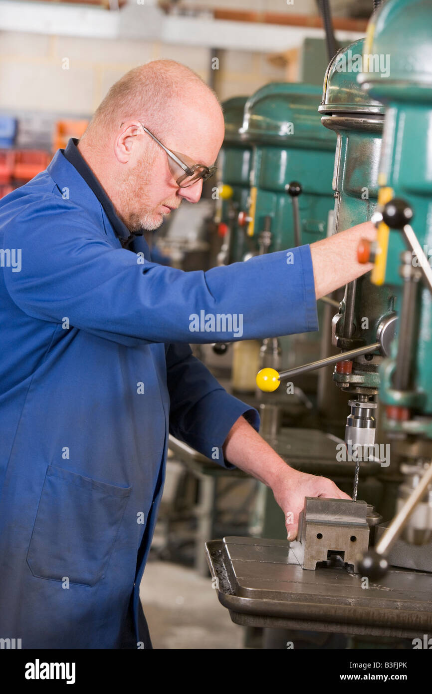 Machinist working on machine Stock Photo - Alamy