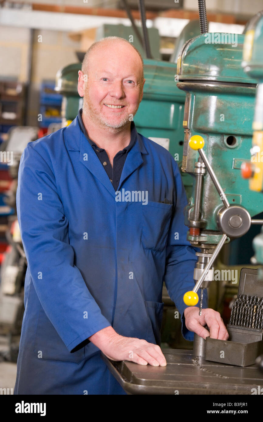 Machinist working on machine Stock Photo - Alamy