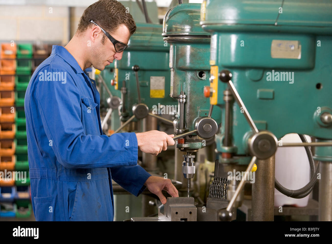 Machinist working on machine Stock Photo - Alamy