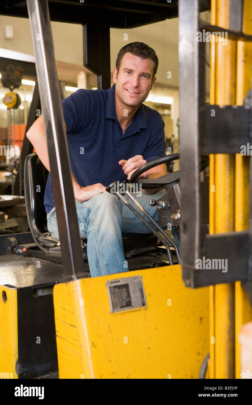 Warehouse worker in forklift Stock Photo - Alamy