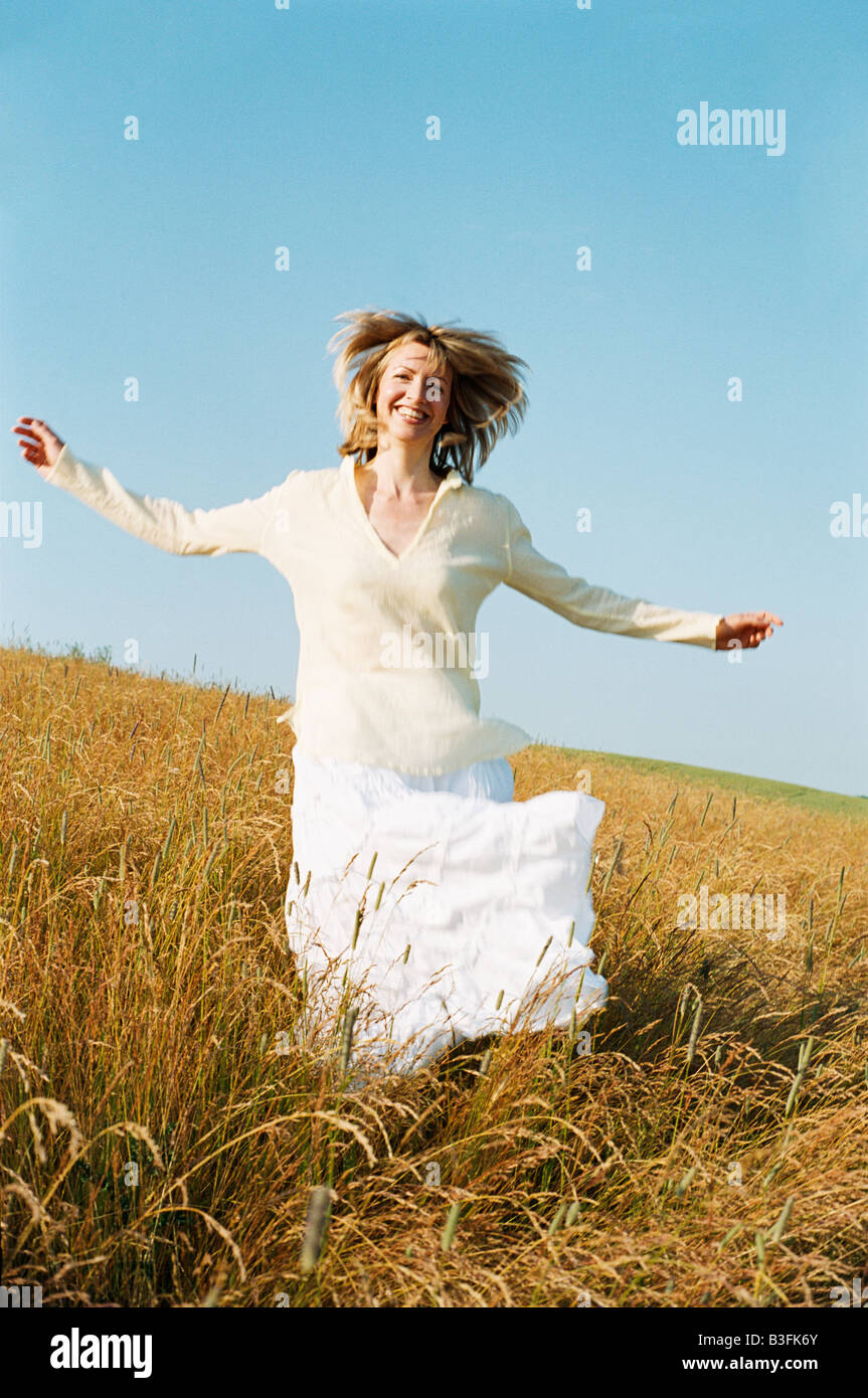 Woman running outdoors smiling Stock Photo - Alamy
