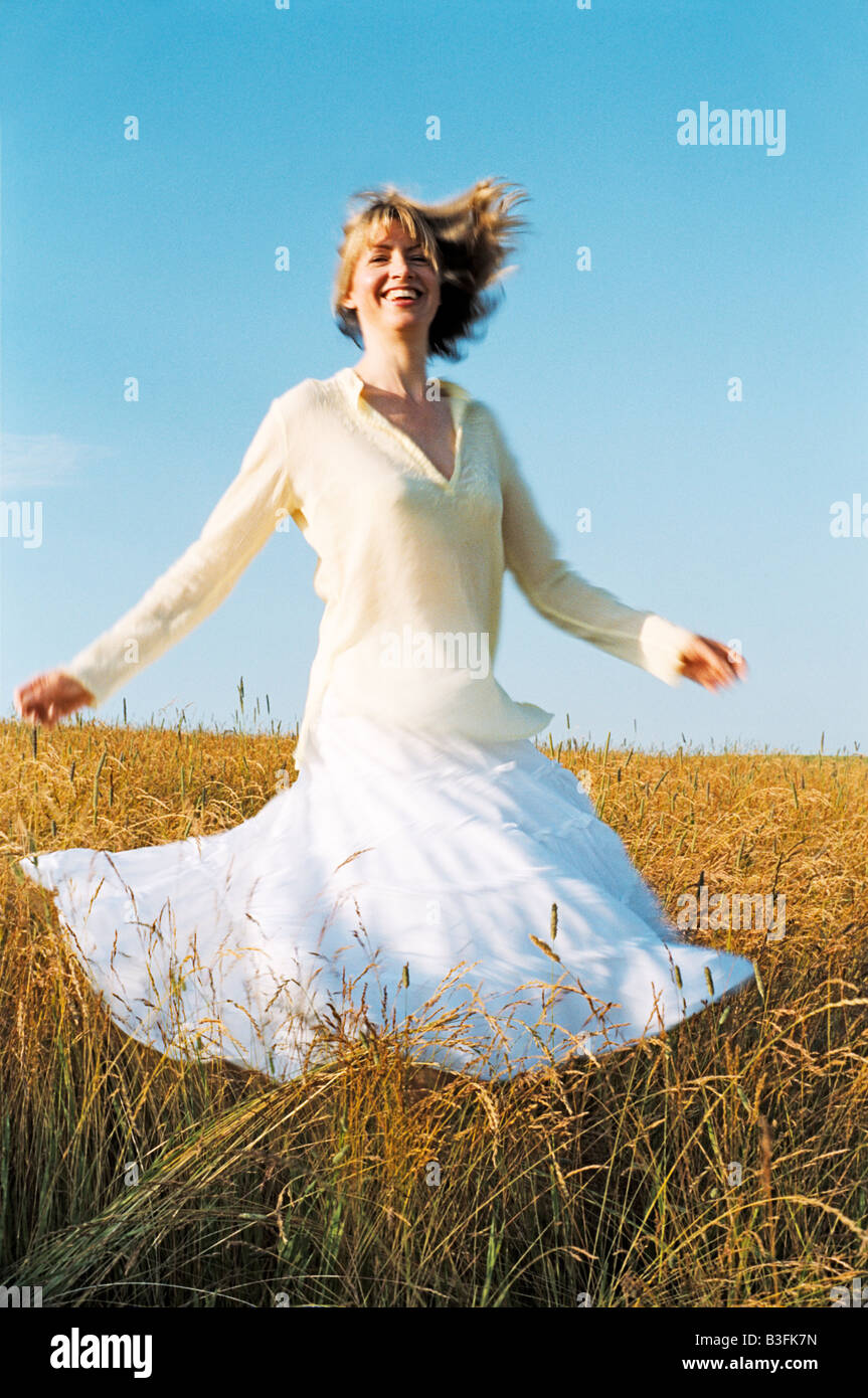 Woman spinning outdoors smiling Stock Photo - Alamy