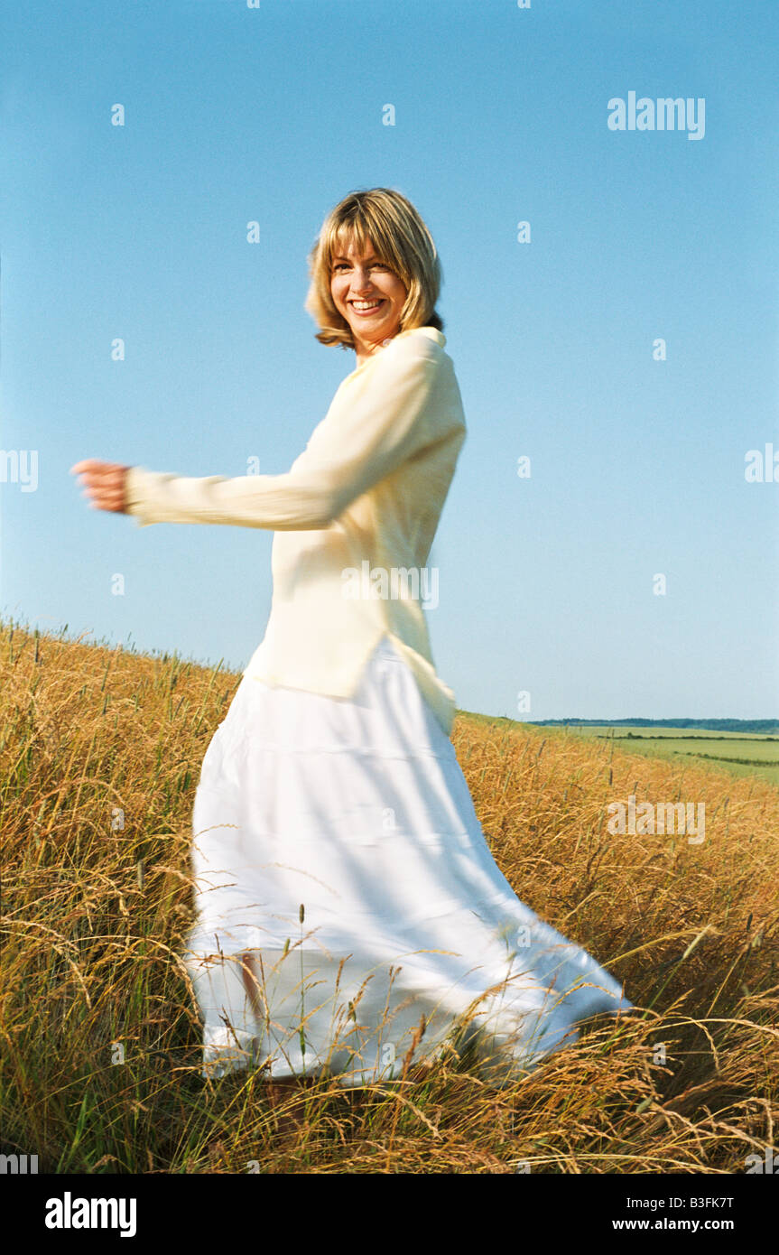 Woman spinning outdoors smiling Stock Photo - Alamy