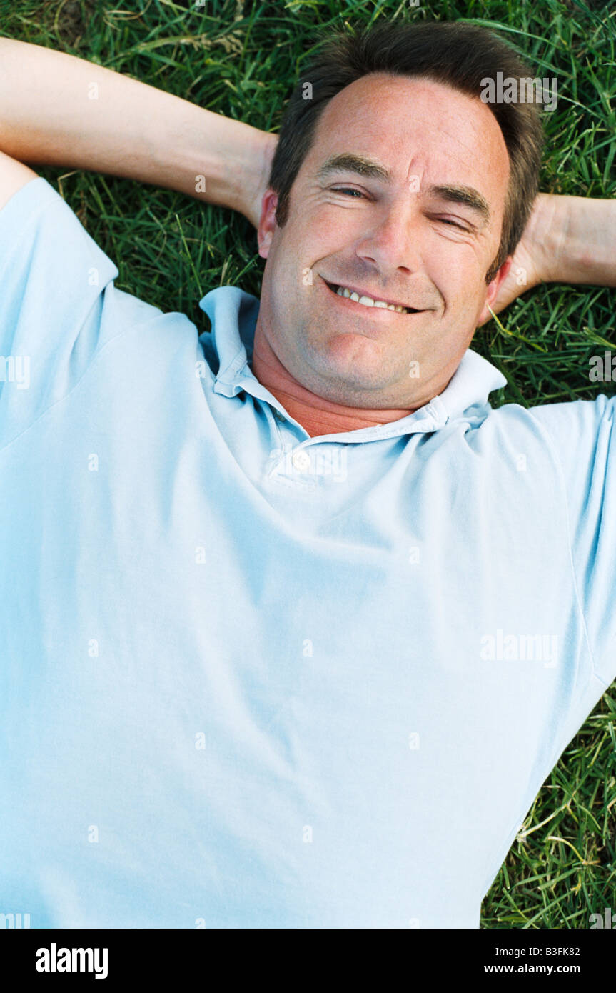 Man lying outdoors smiling Stock Photo - Alamy