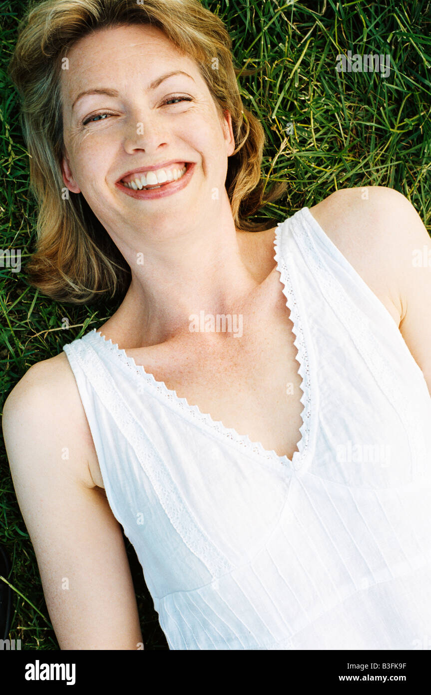 Woman lying outdoors smiling Stock Photo - Alamy