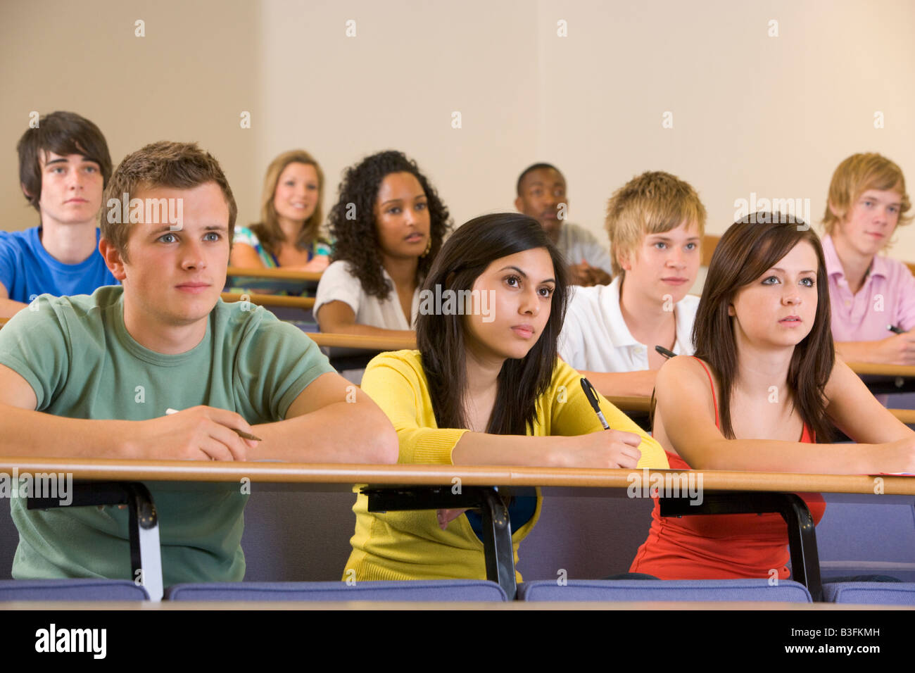 Students in class paying attention and taking notes (depth of field ...