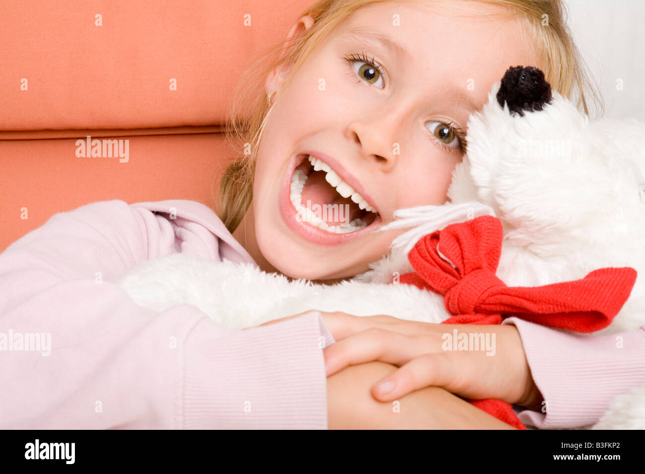 girl cuddling teddy Stock Photo - Alamy