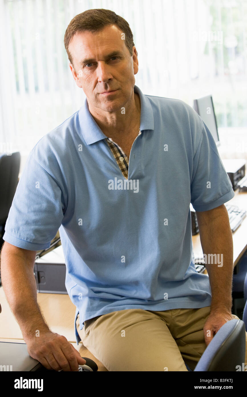 Teacher by computer terminals smiling (high key Stock Photo - Alamy