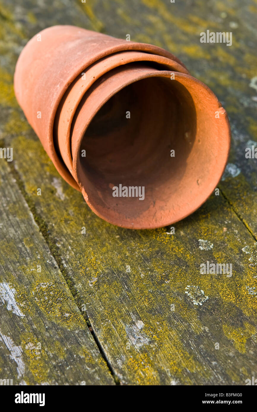 Close up old terracotta flowerpots stack stacked table garden uk hi-res ...