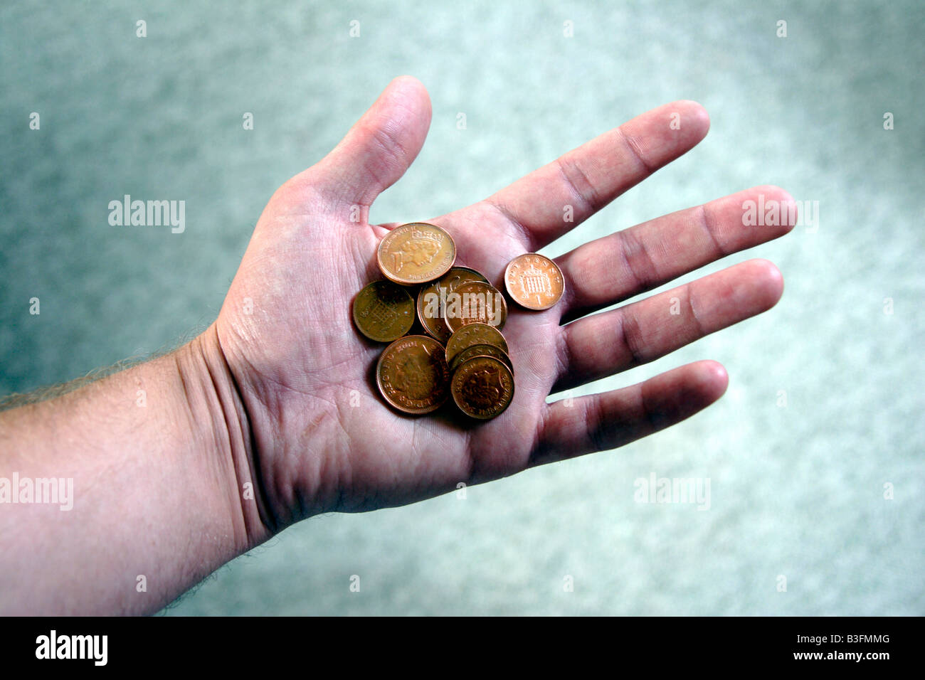 Copper change in palm of hand close up Stock Photo - Alamy
