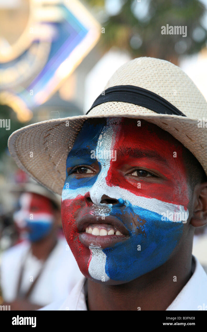 Carnival participant with Dominican flag on his face performing during ...