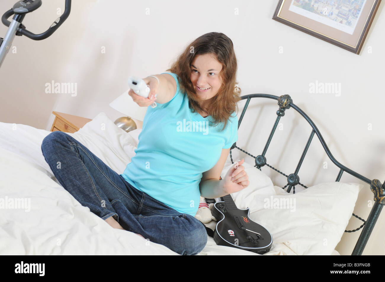 a girl playing on a nintendo wii computer game in her bedroom Stock ...