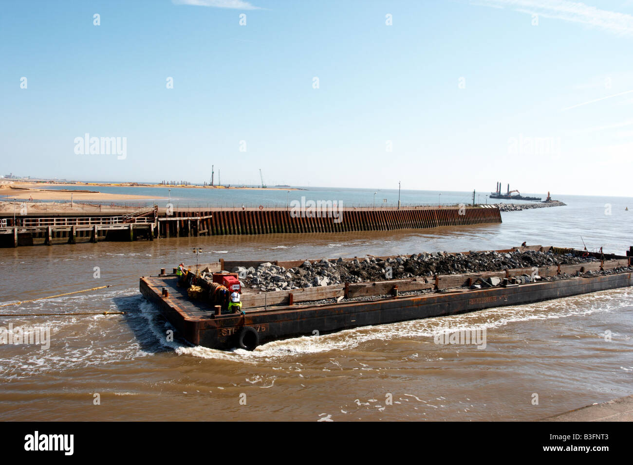 barge carry rock,coming into harbour Stock Photo - Alamy