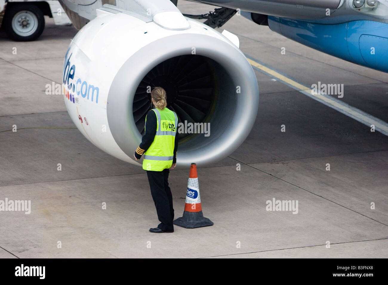Safety check by pilot before take off pilot checking jet engine head in ...