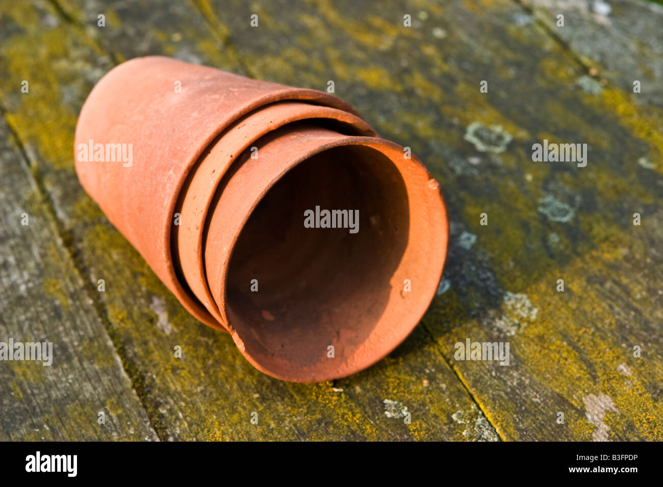 Close up old terracotta flowerpots stack stacked table garden uk hi-res ...