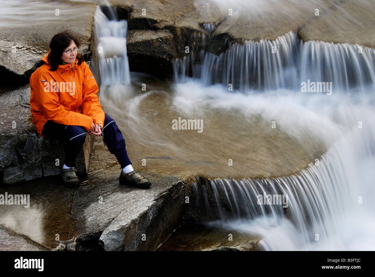 woman sitting on a stream lapland sweden Stock Photo - Alamy