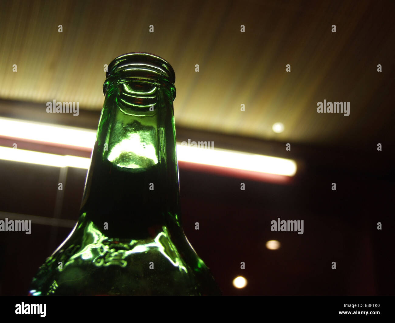 beer bottle detail inside dark room at night Stock Photo - Alamy