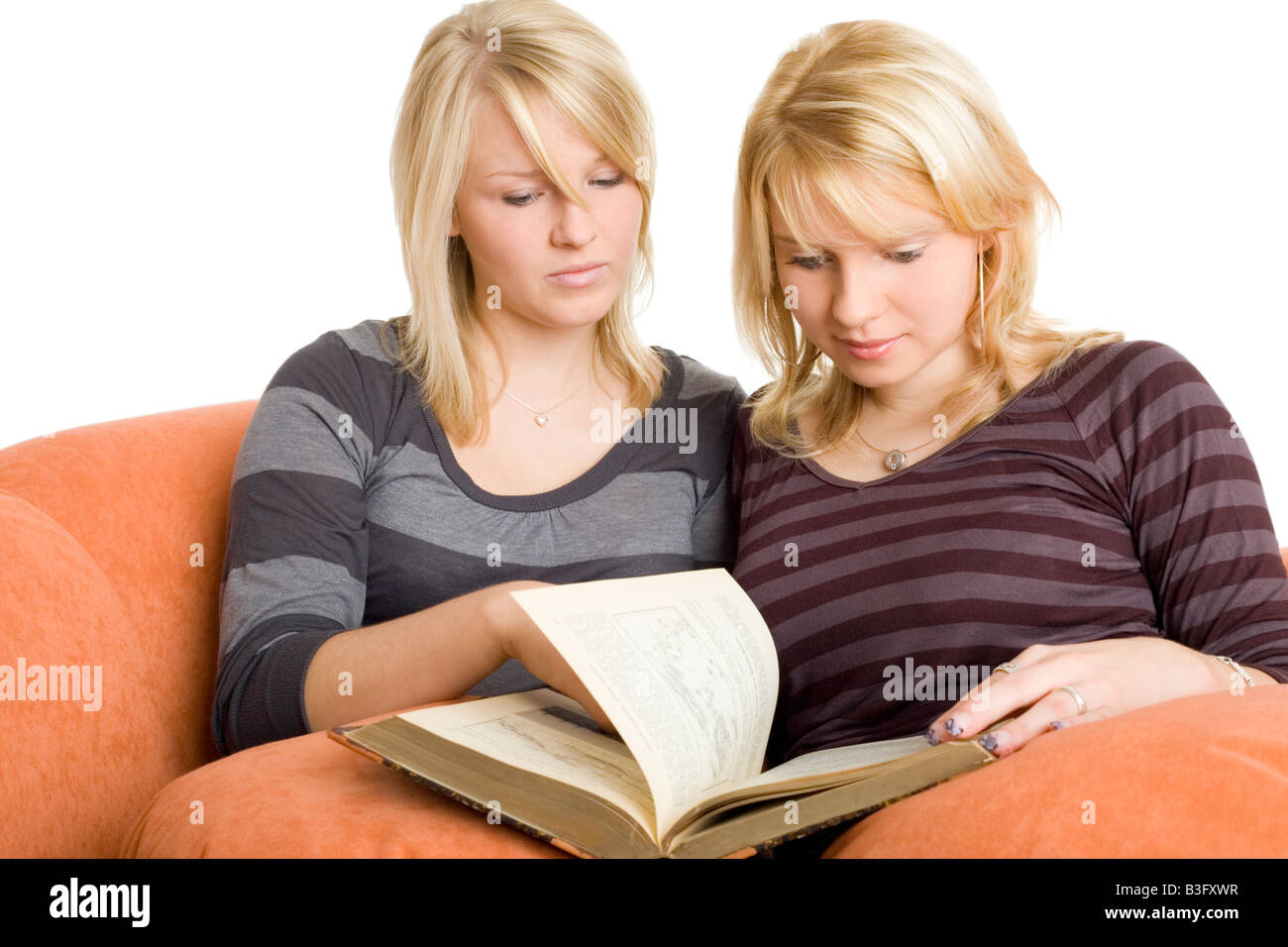 blond friends reading book Stock Photo - Alamy