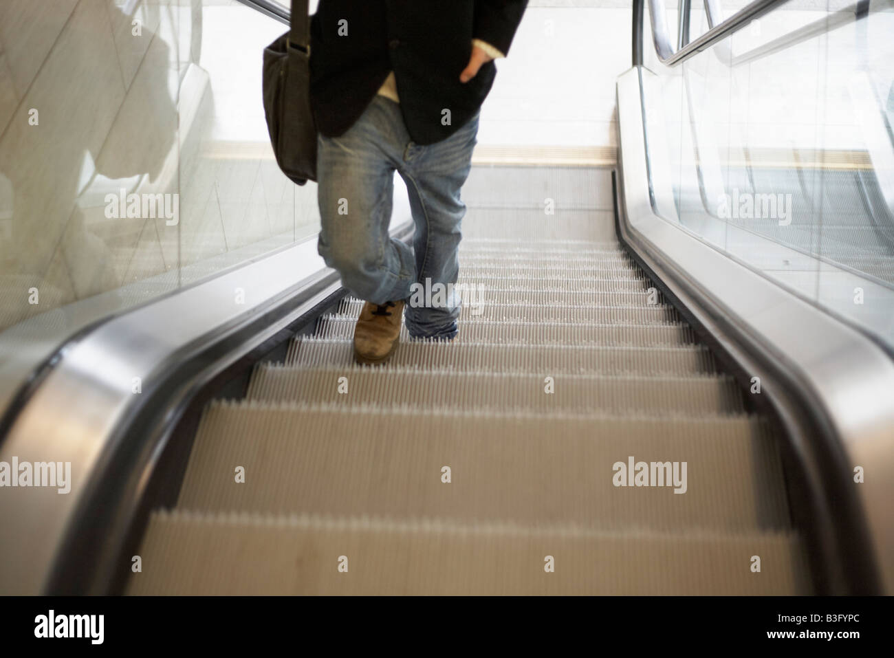Teenager walking up in escalator, low section Stock Photo - Alamy