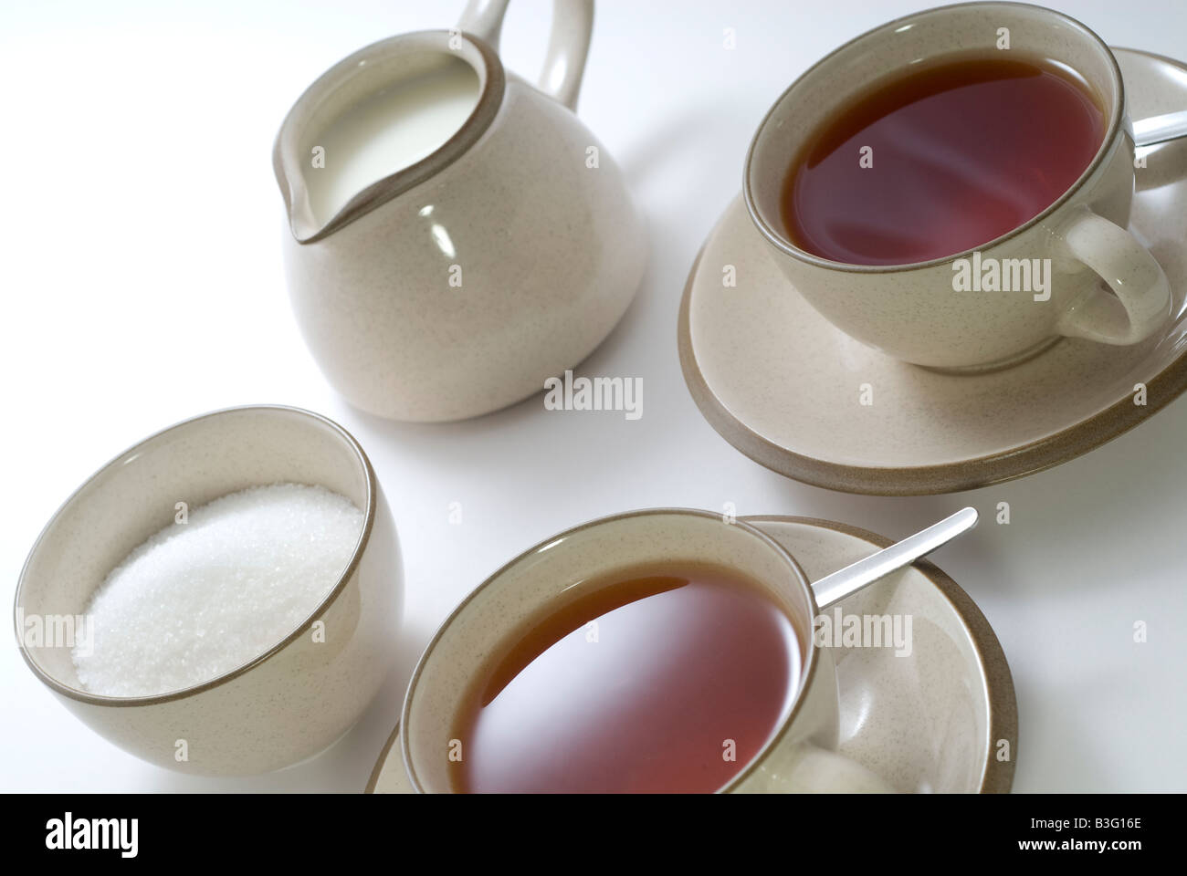 Two cups of black tea with milk and sugar waiting Stock Photo - Alamy