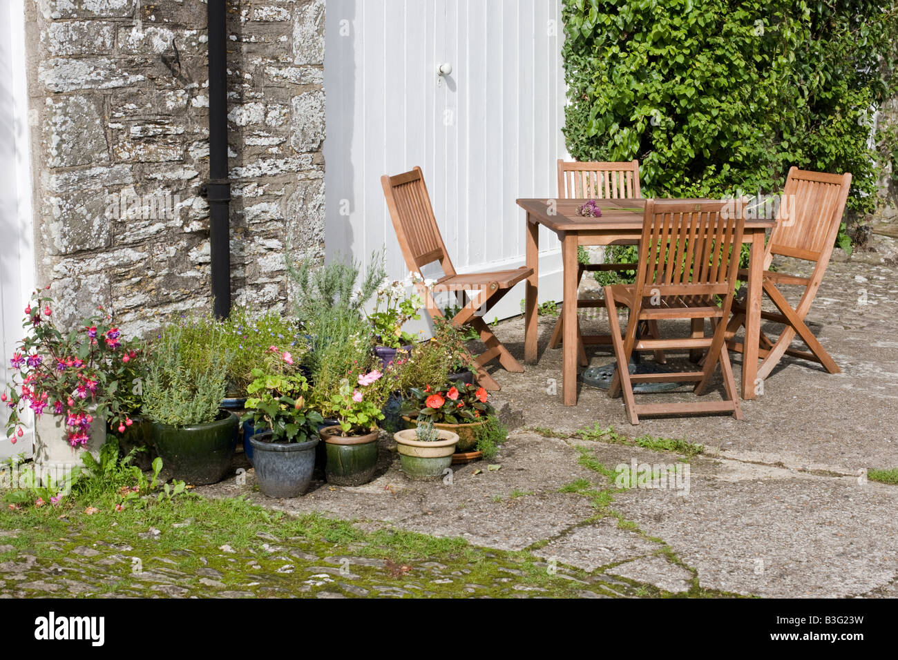 Picnic table and chairs outside country cottage Stock Photo - Alamy
