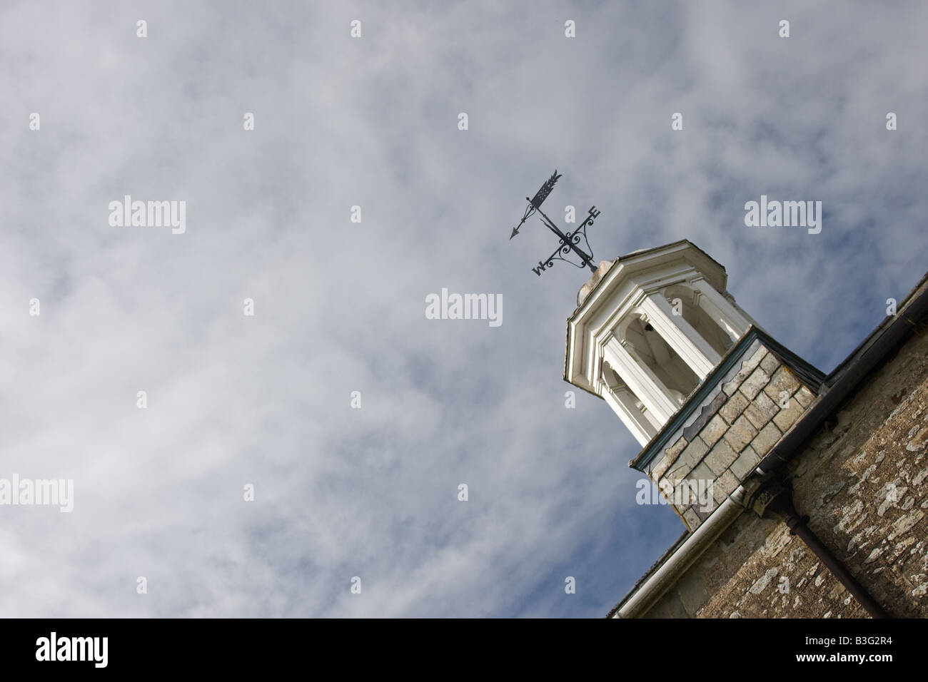 Weather wind vane arrow points west east on a roof in the sky Stock ...