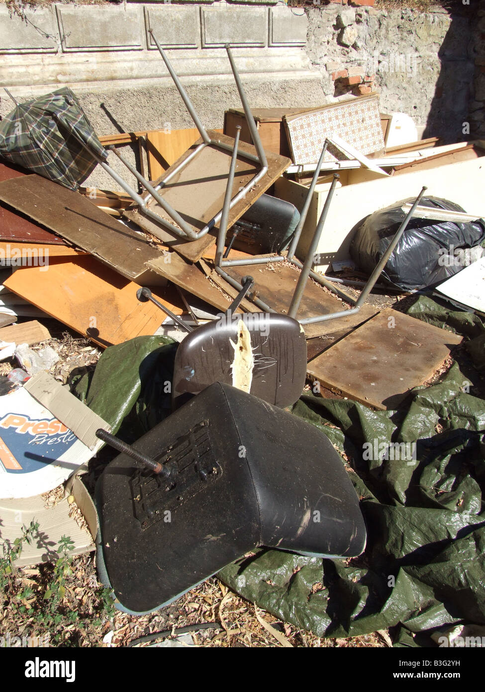 old chairs dumped outdoors in sun Stock Photo - Alamy