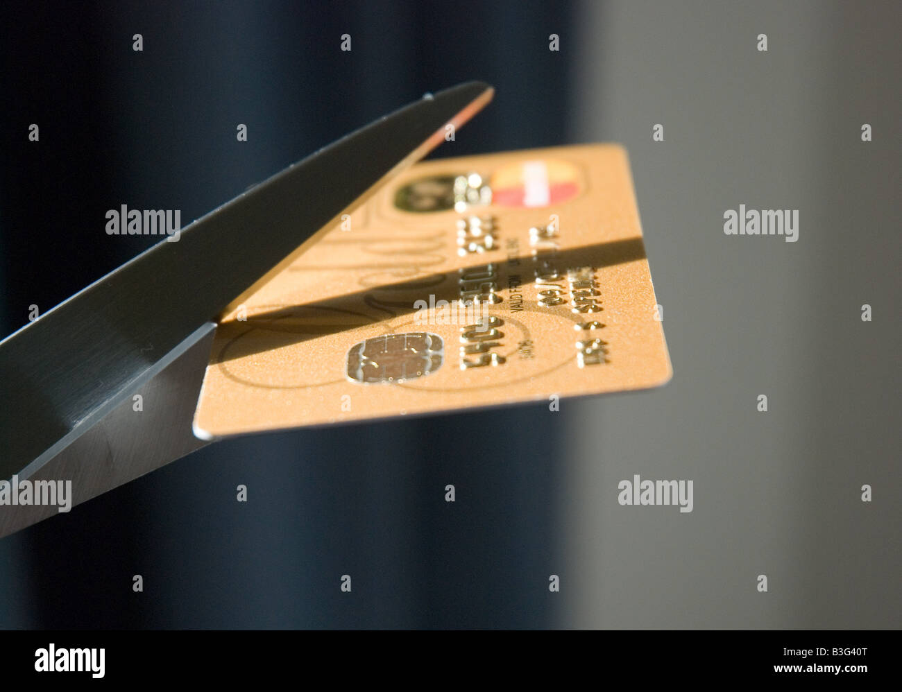 Credit card being cut by scissors Stock Photo - Alamy