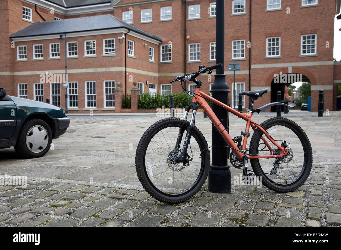 Bicycle chained to a lampost in Leeds City Centre West Yorkshire UK ...