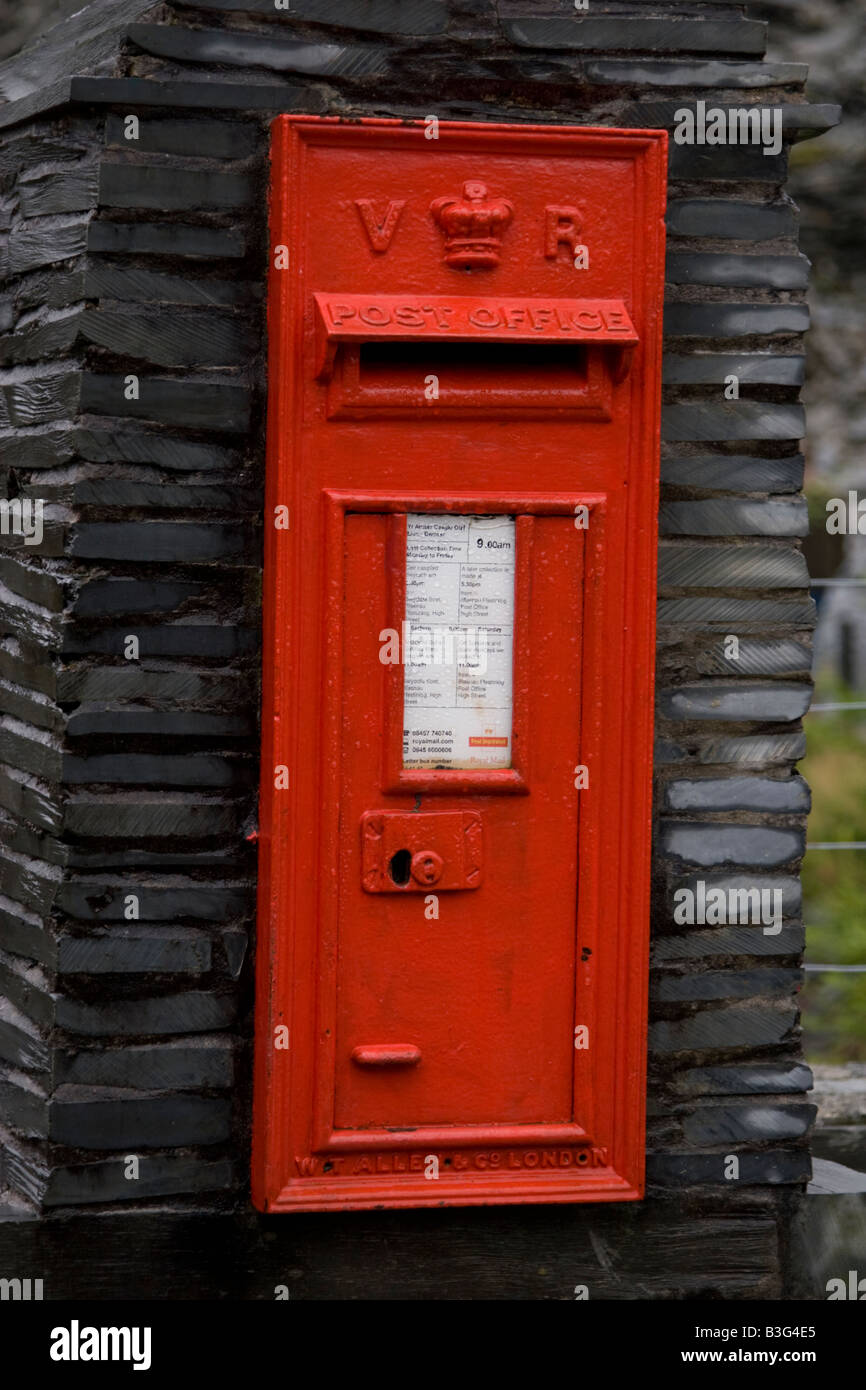 Bright red Royal Mail post box on grey slate wall Stock Photo - Alamy