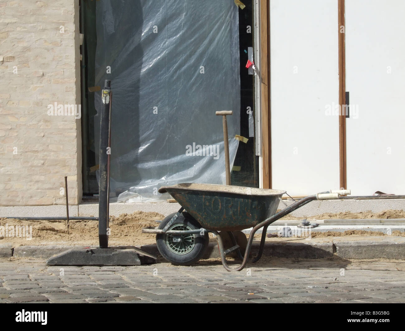 one wheelbarrow at building site in city town Stock Photo - Alamy