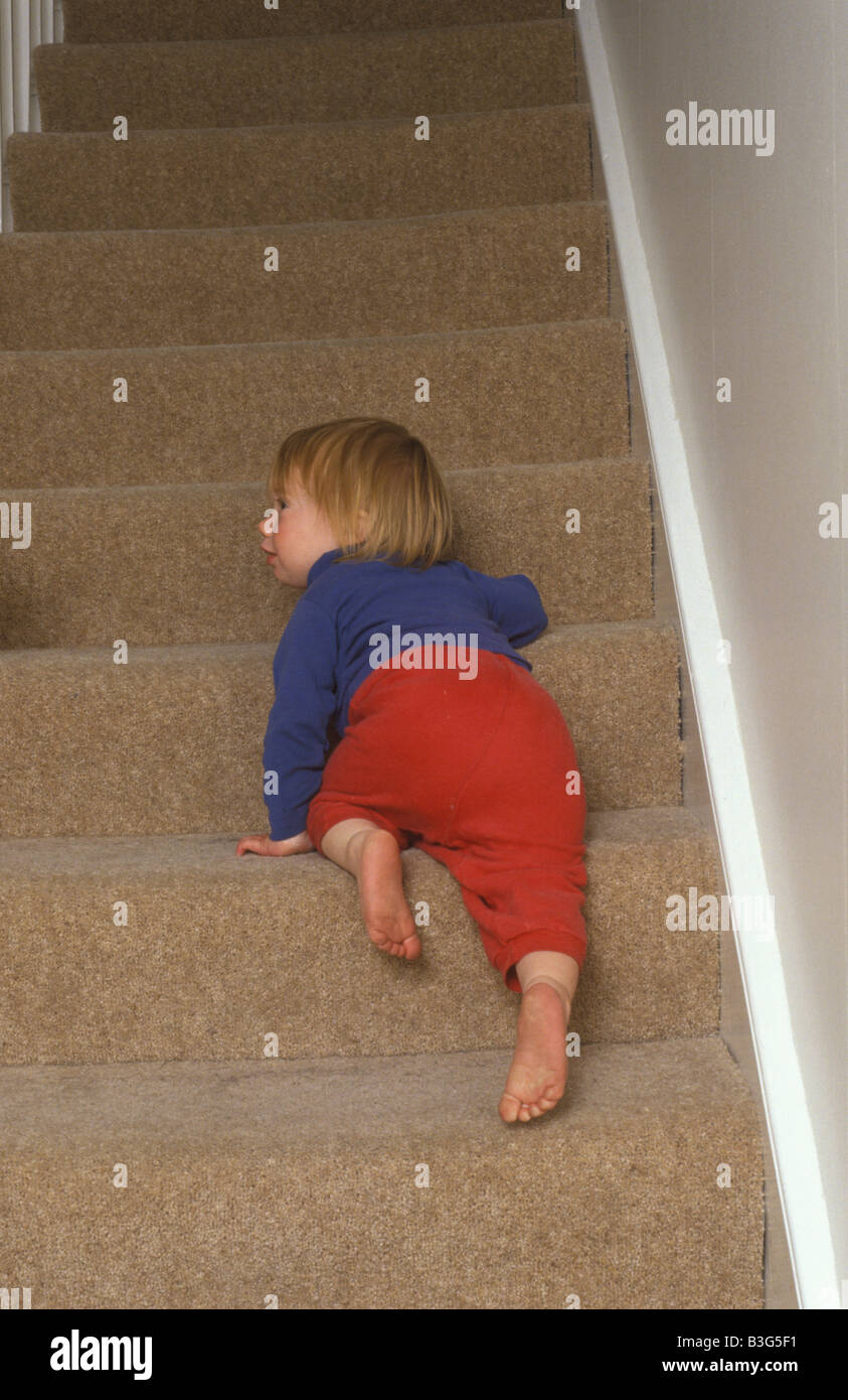 toddler learning to crawl upstairs Stock Photo - Alamy