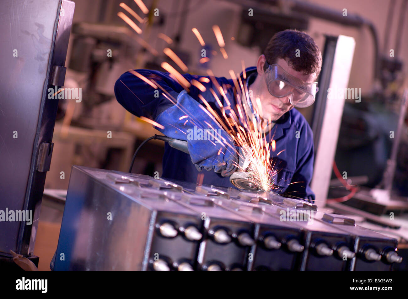 FACTORY WORKER GRINDING Stock Photo - Alamy