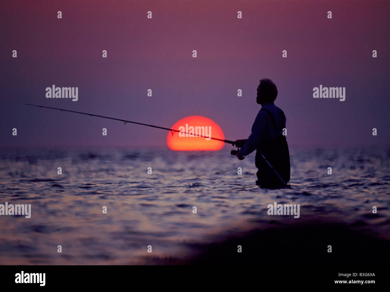 Off-shore angler at sunset Stock Photo - Alamy