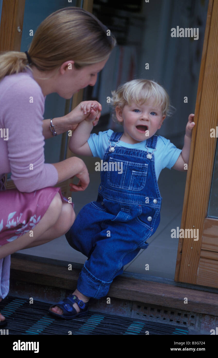 Holding hands and helping a toddler hi-res stock photography and images ...