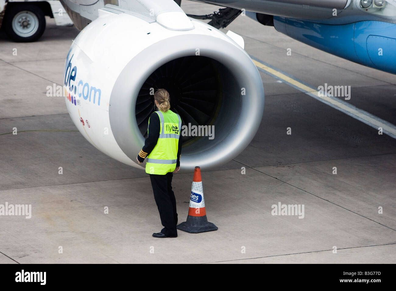 Safety check by pilot before take off pilot checking jet engine head in ...