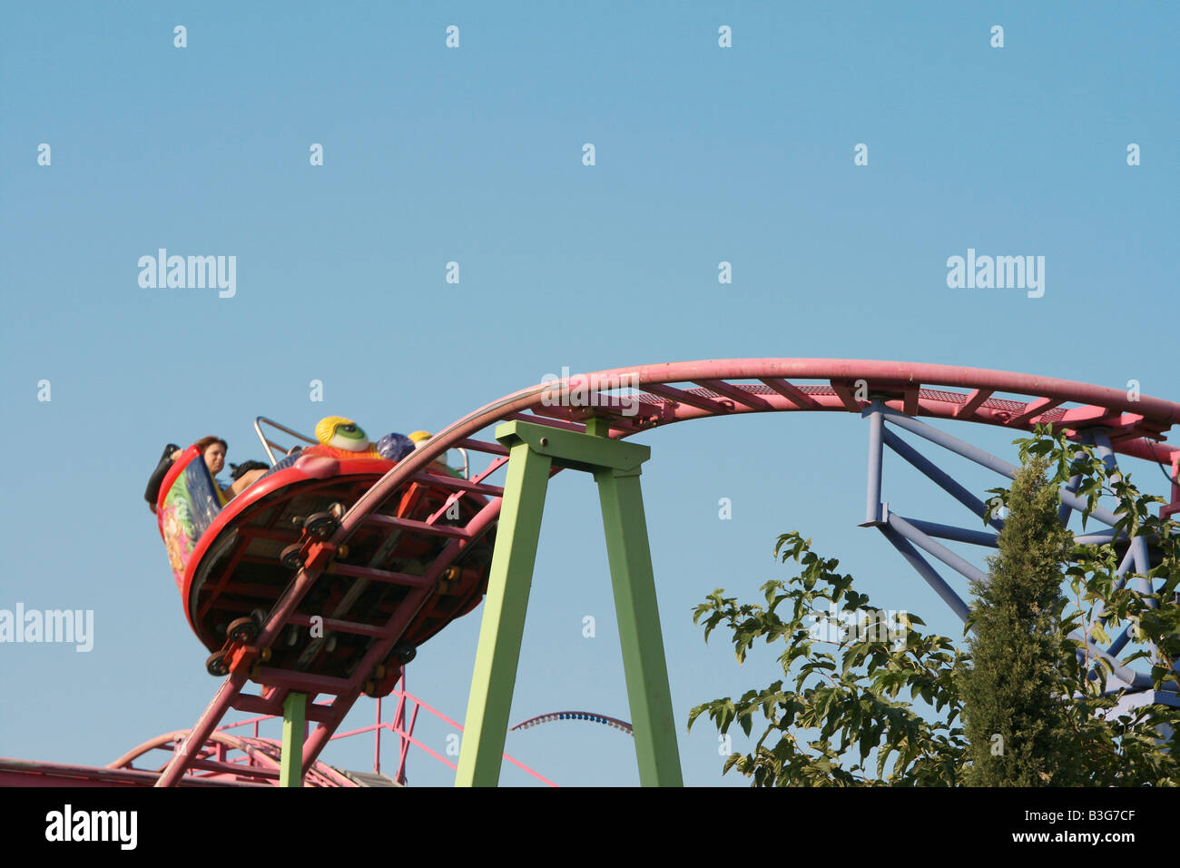 amusement park ride at roller coaster against blue sky Stock Photo - Alamy