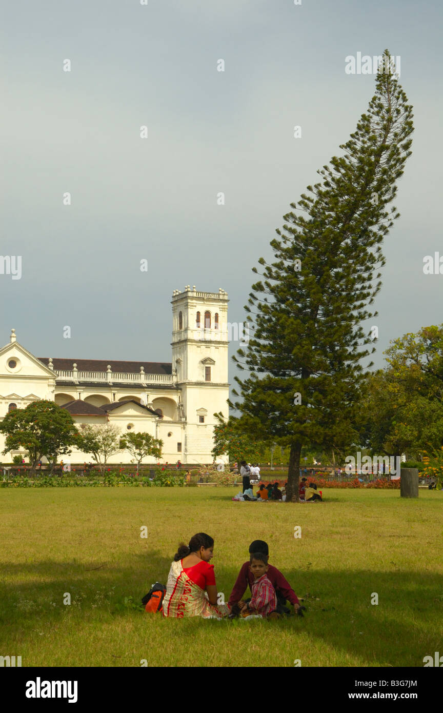 India Goa Old Goa. Indian family having a picnic on the green in front ...