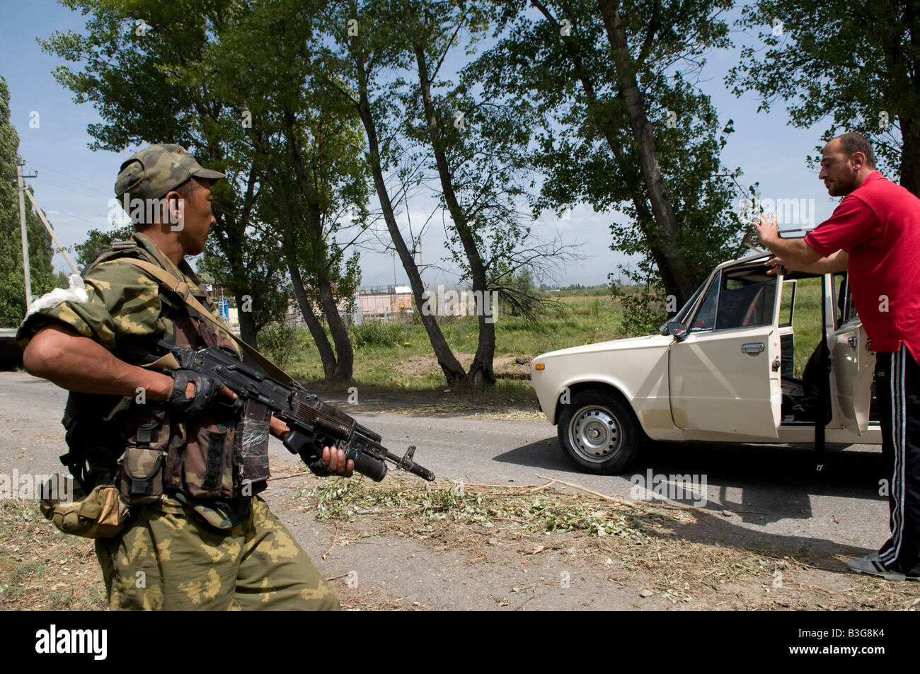 An ethnic Russian soldier with a Kalashnikov ak-47 rifle stops a ...
