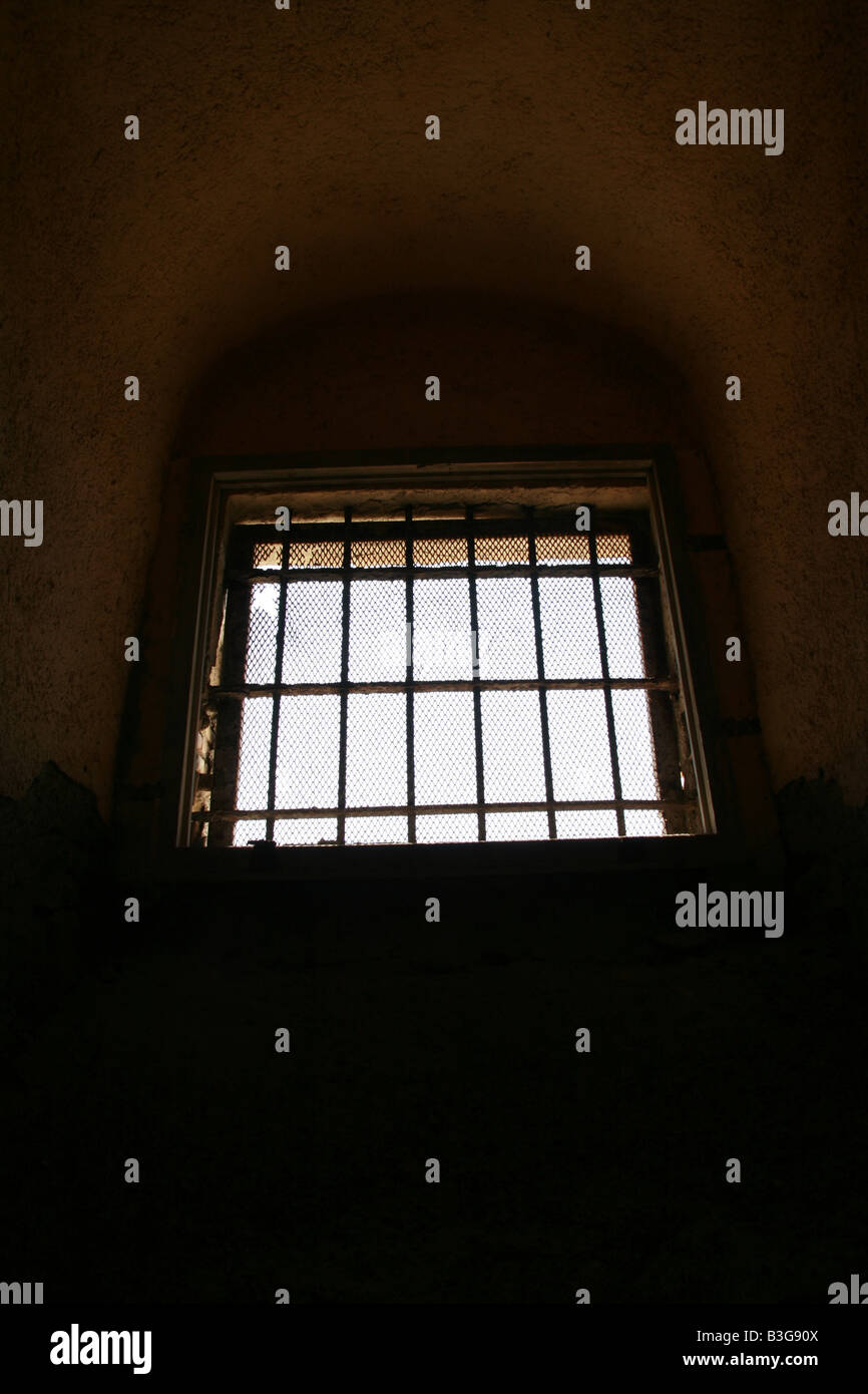 one high dark prison cell window with metal bars Stock Photo - Alamy