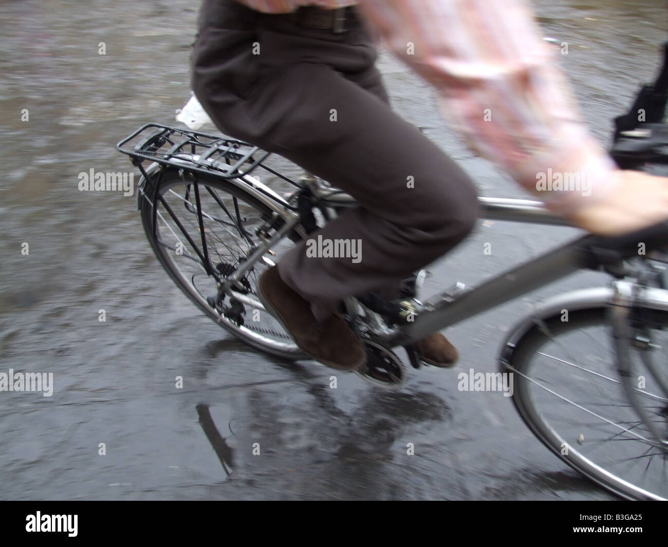commuter riding bike on street road in city town Stock Photo - Alamy