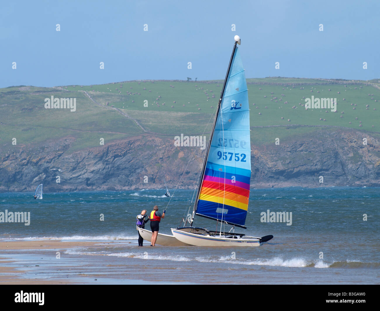 Couple with a catamaran beached at Padstow beach, Cornwall, UK Stock ...