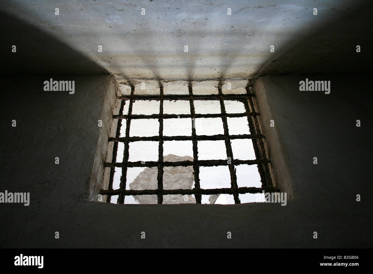 one high dark prison cell window with metal bars Stock Photo - Alamy